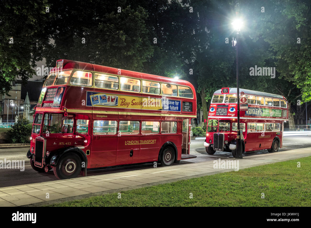 Two red London buses at night Stock Photo - Alamy