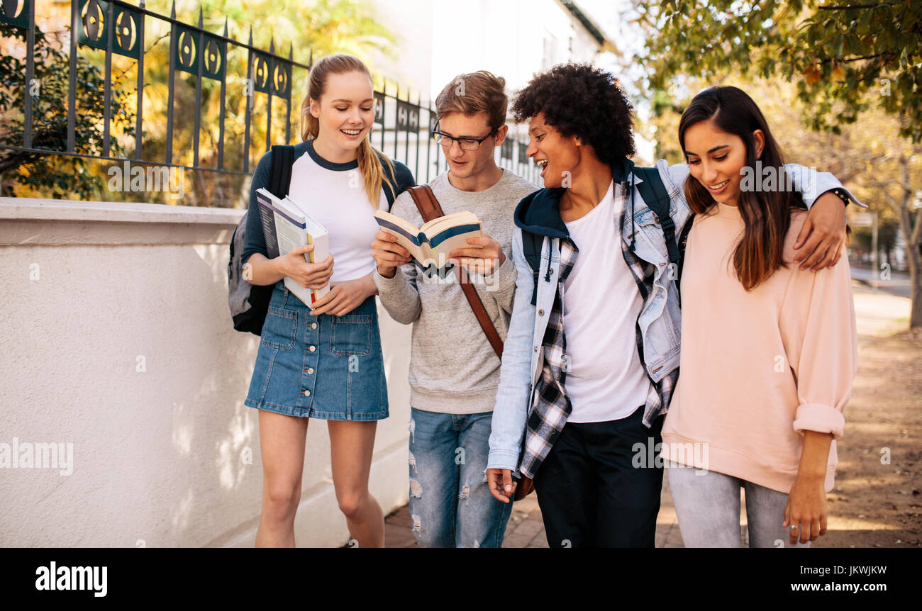 Group of university students with books in college campus. College ...
