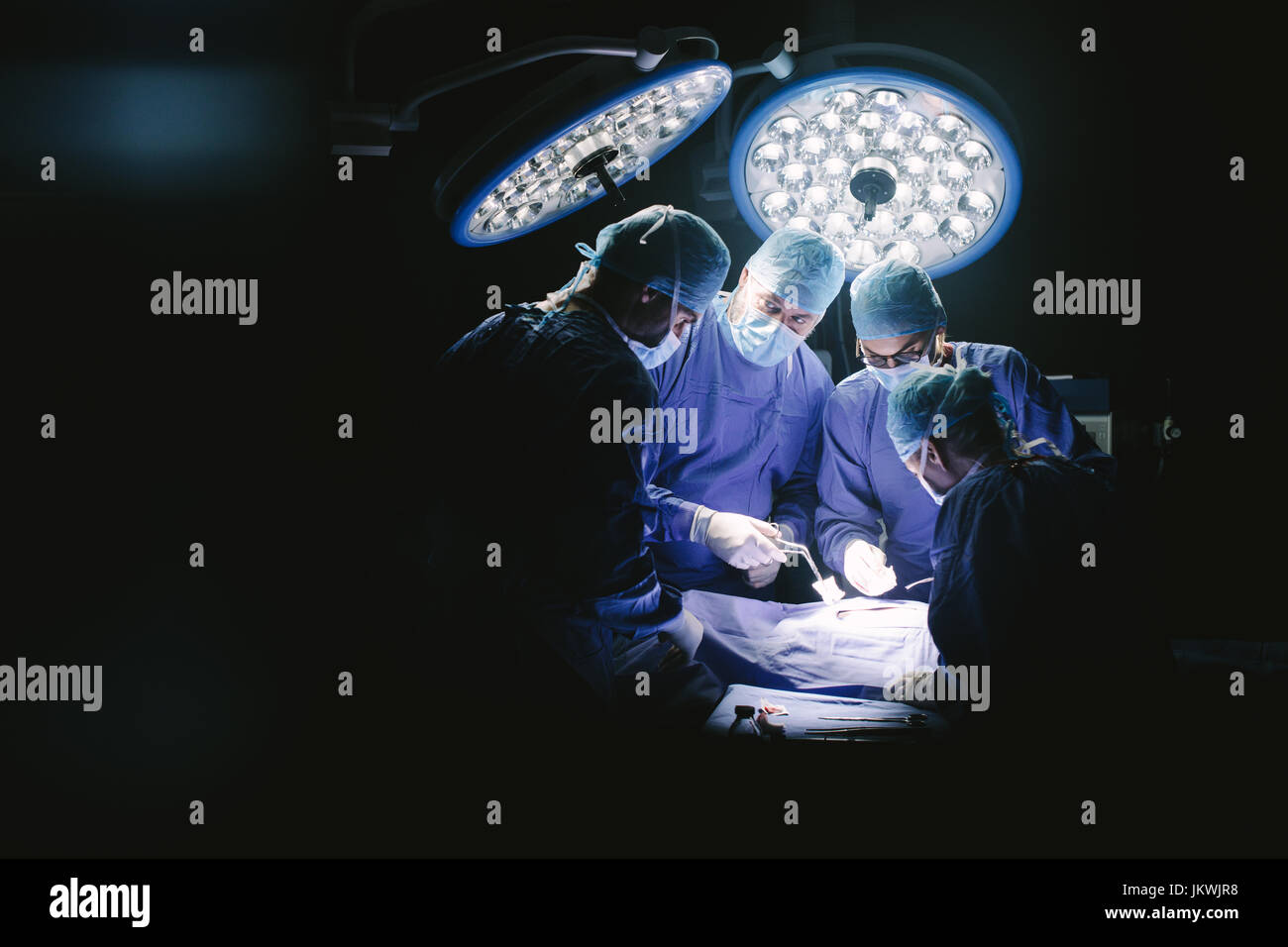 Group of surgeons in hospital operating theater. Medical team ...