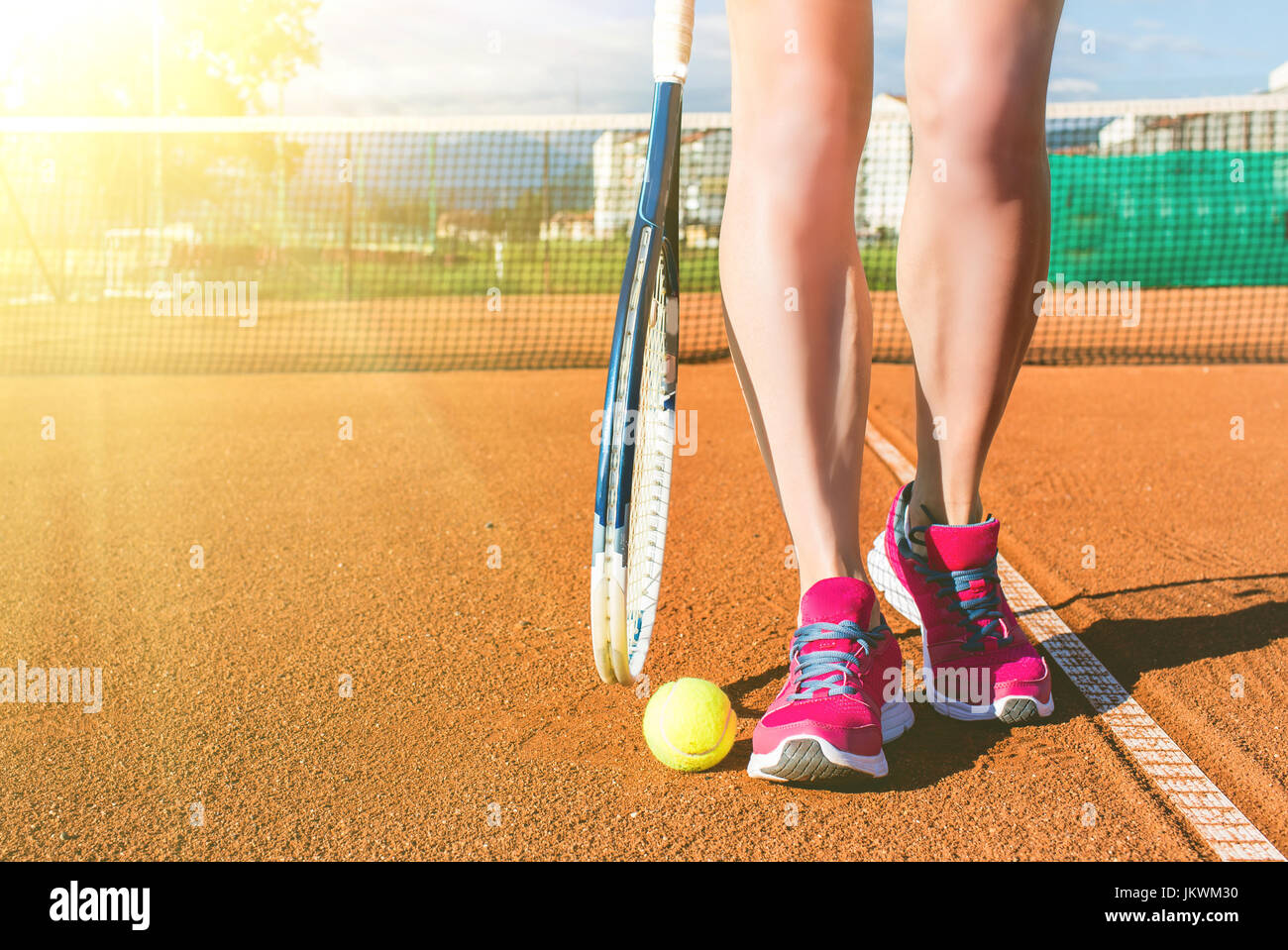 Closeup photo of female legs with tennis racket Stock Photo - Alamy