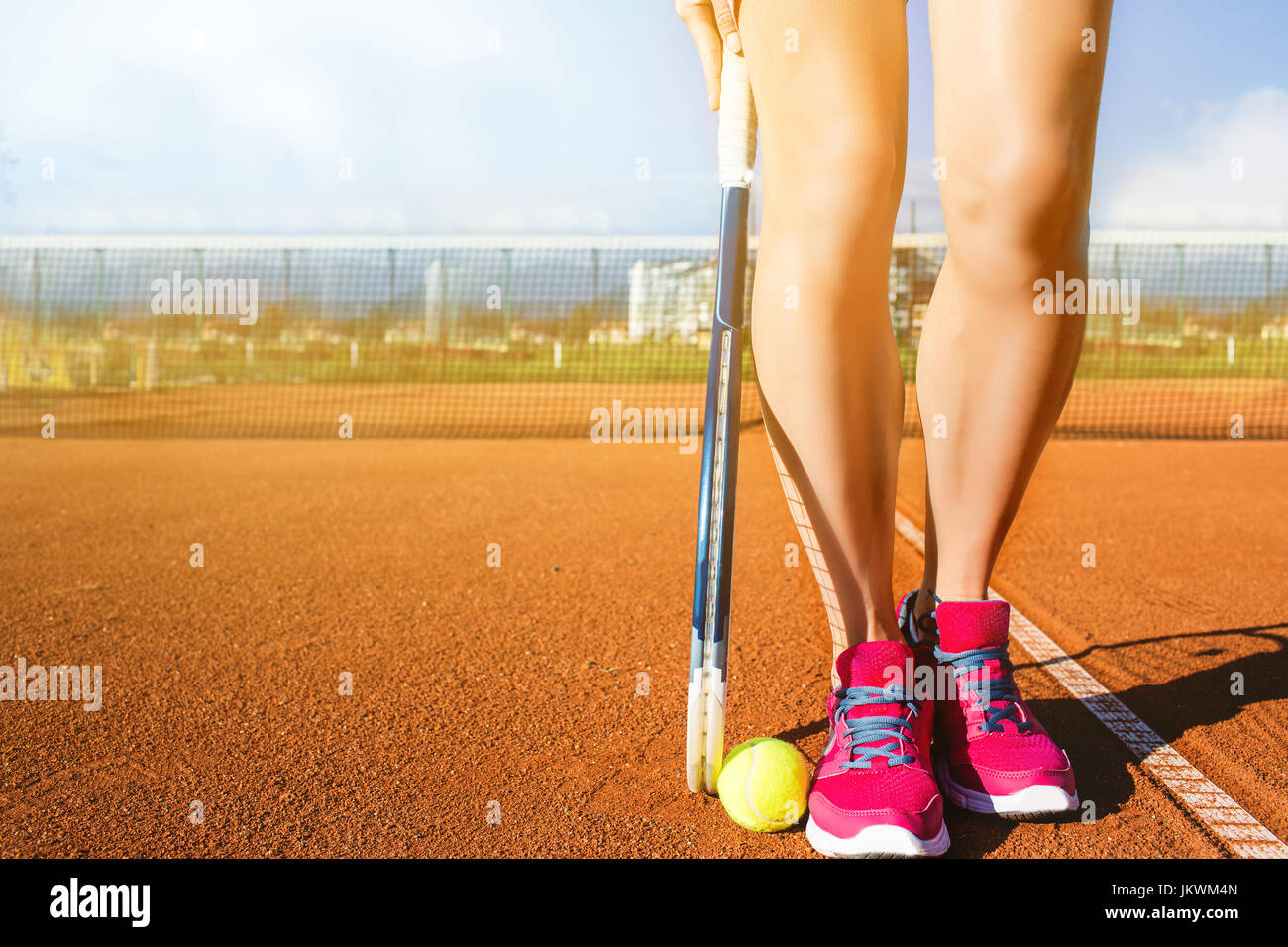 Closeup photo of female legs with tennis racket Stock Photo - Alamy