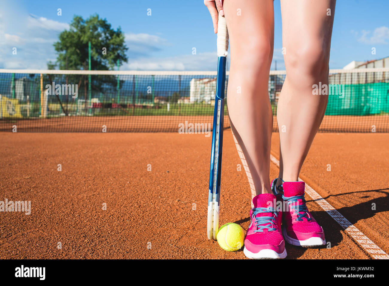 Closeup photo of female legs with tennis racket Stock Photo - Alamy