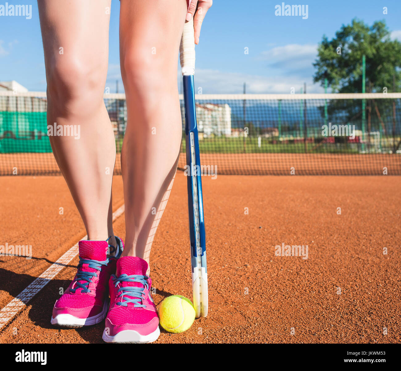 Closeup photo of female legs with tennis racket Stock Photo - Alamy