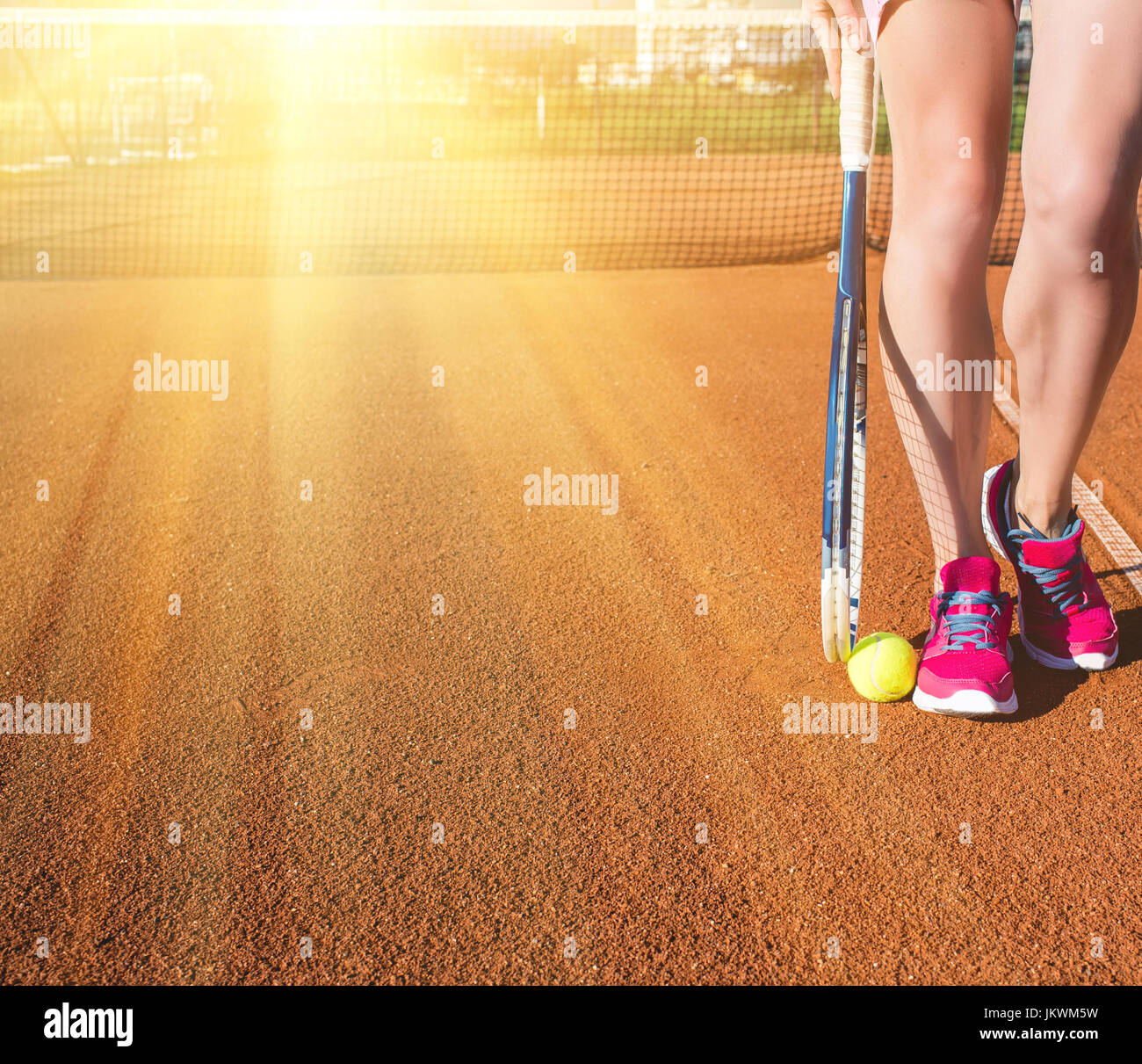 Closeup photo of female legs with tennis racket Stock Photo - Alamy