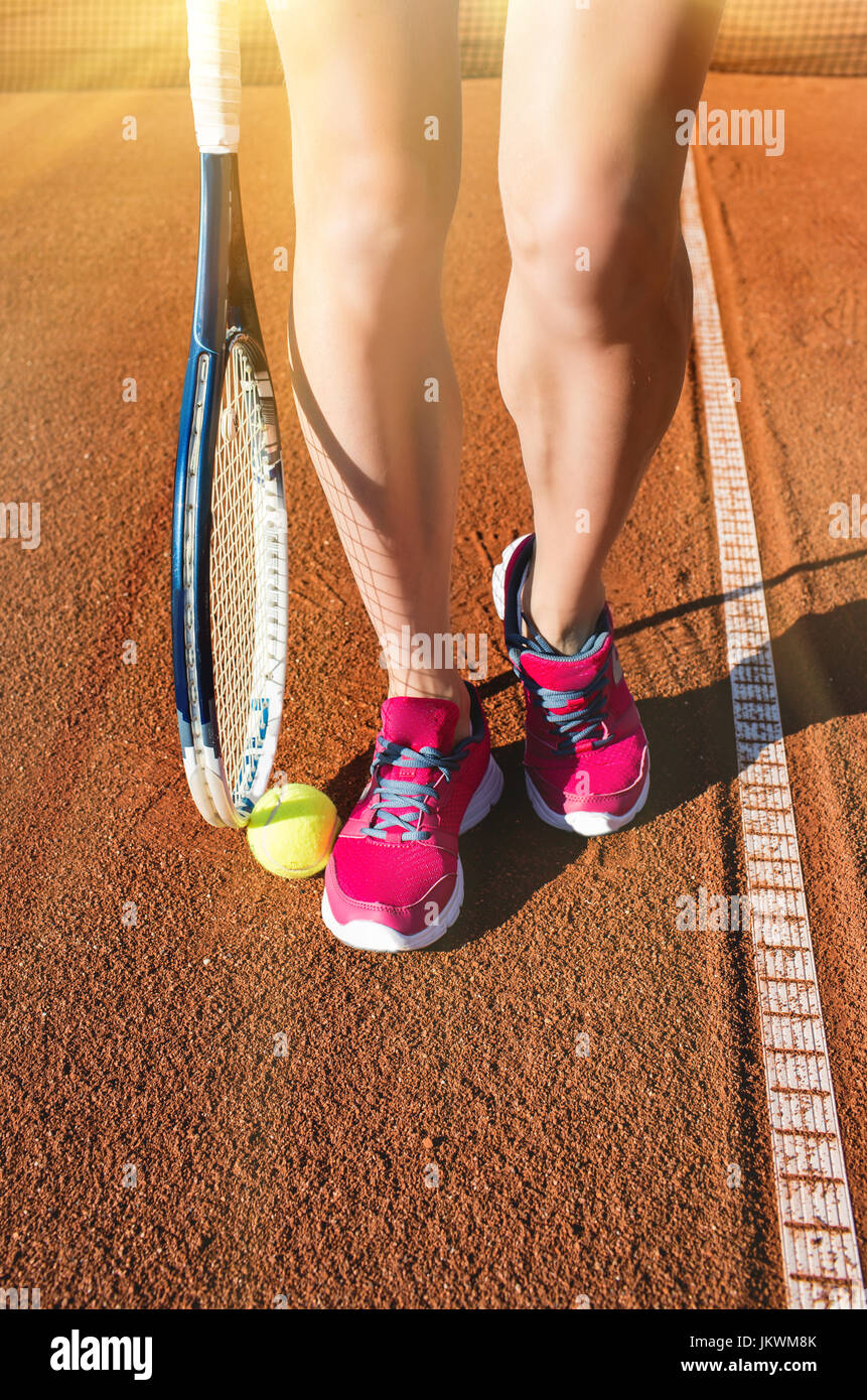 Closeup photo of female legs with tennis racket Stock Photo - Alamy