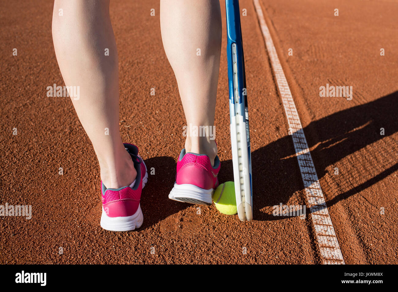 Closeup photo of female legs with tennis racket Stock Photo - Alamy