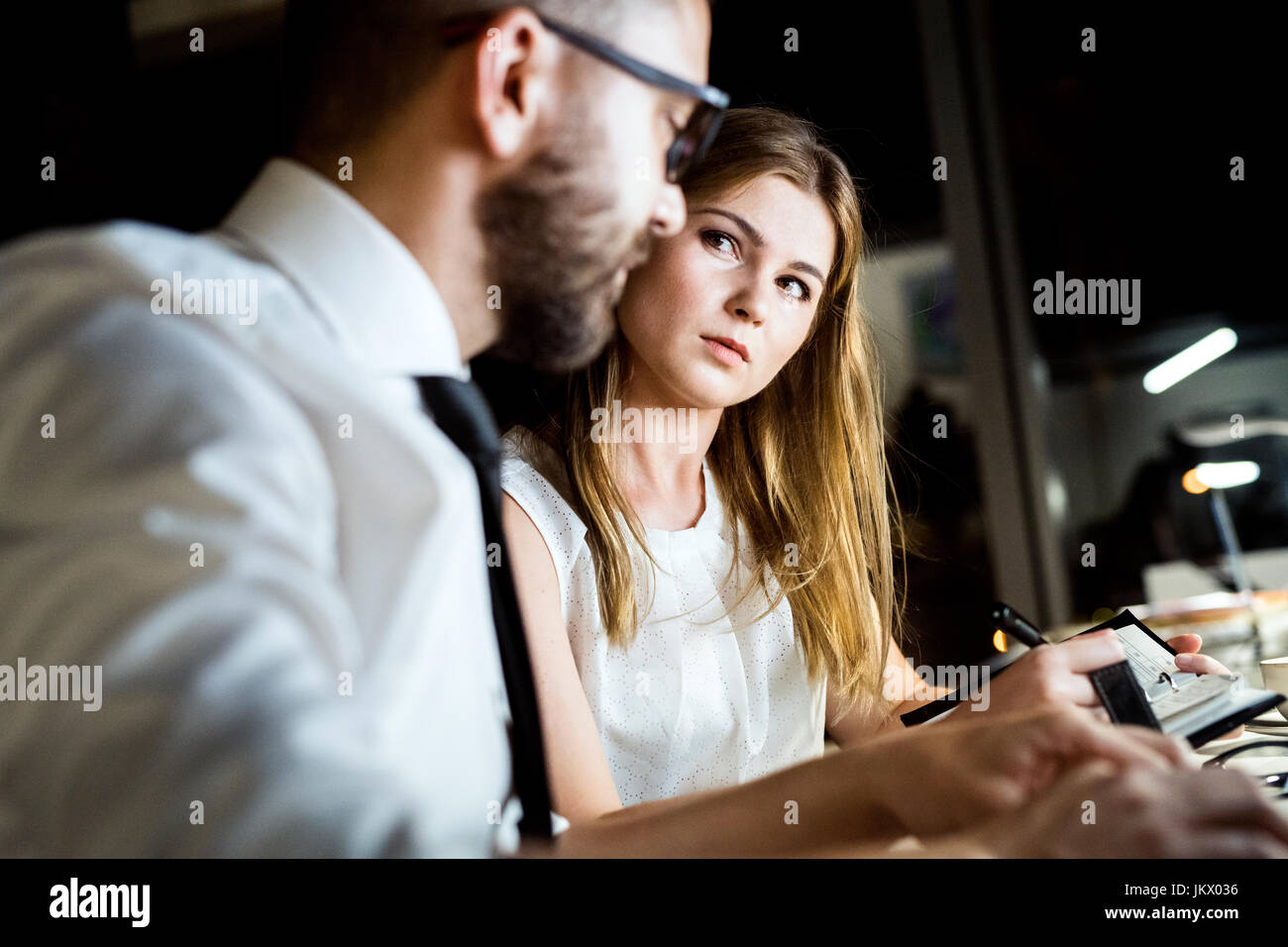 Business people in the office at night working late Stock Photo - Alamy