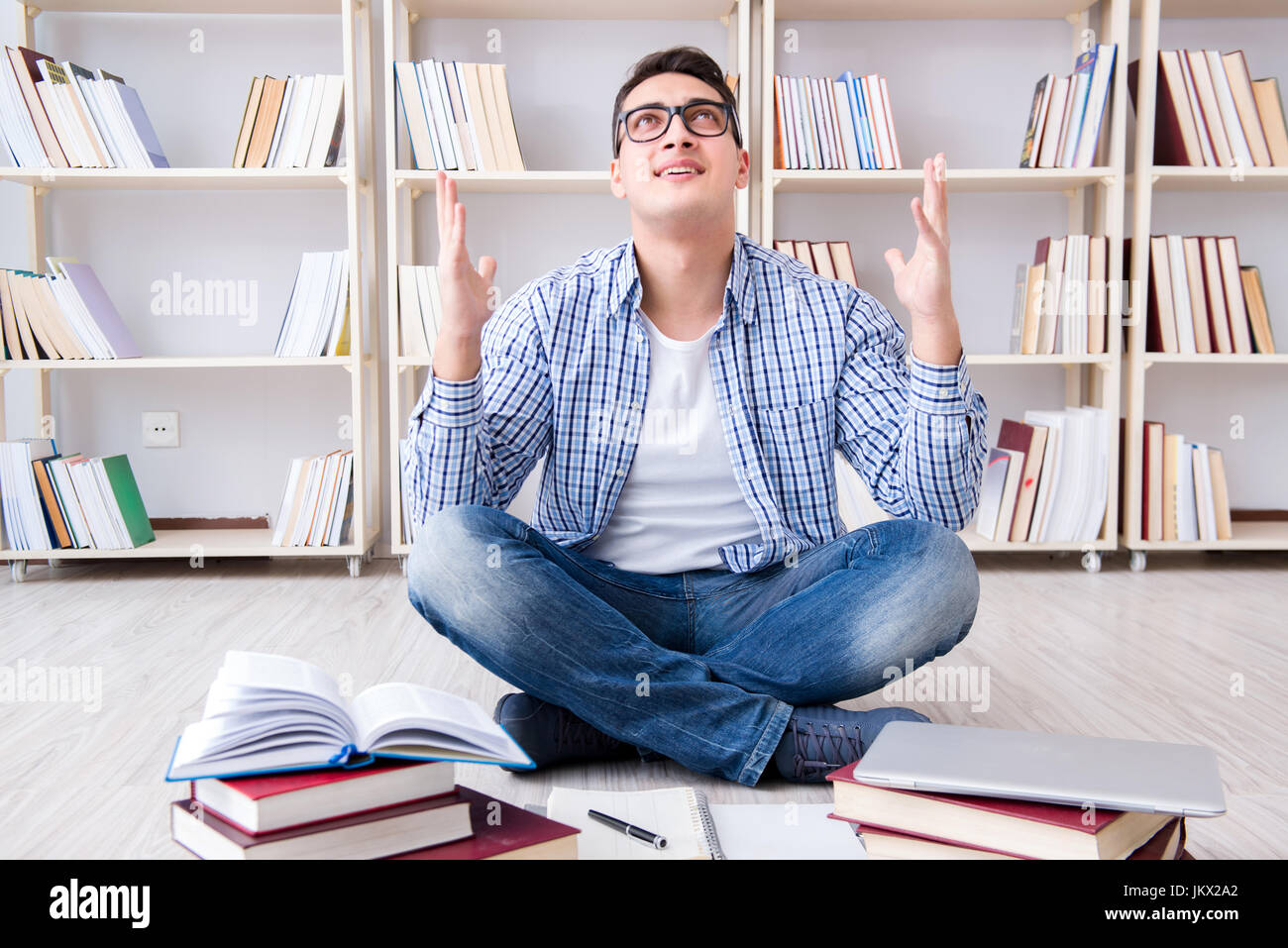 Young student studying with books Stock Photo - Alamy