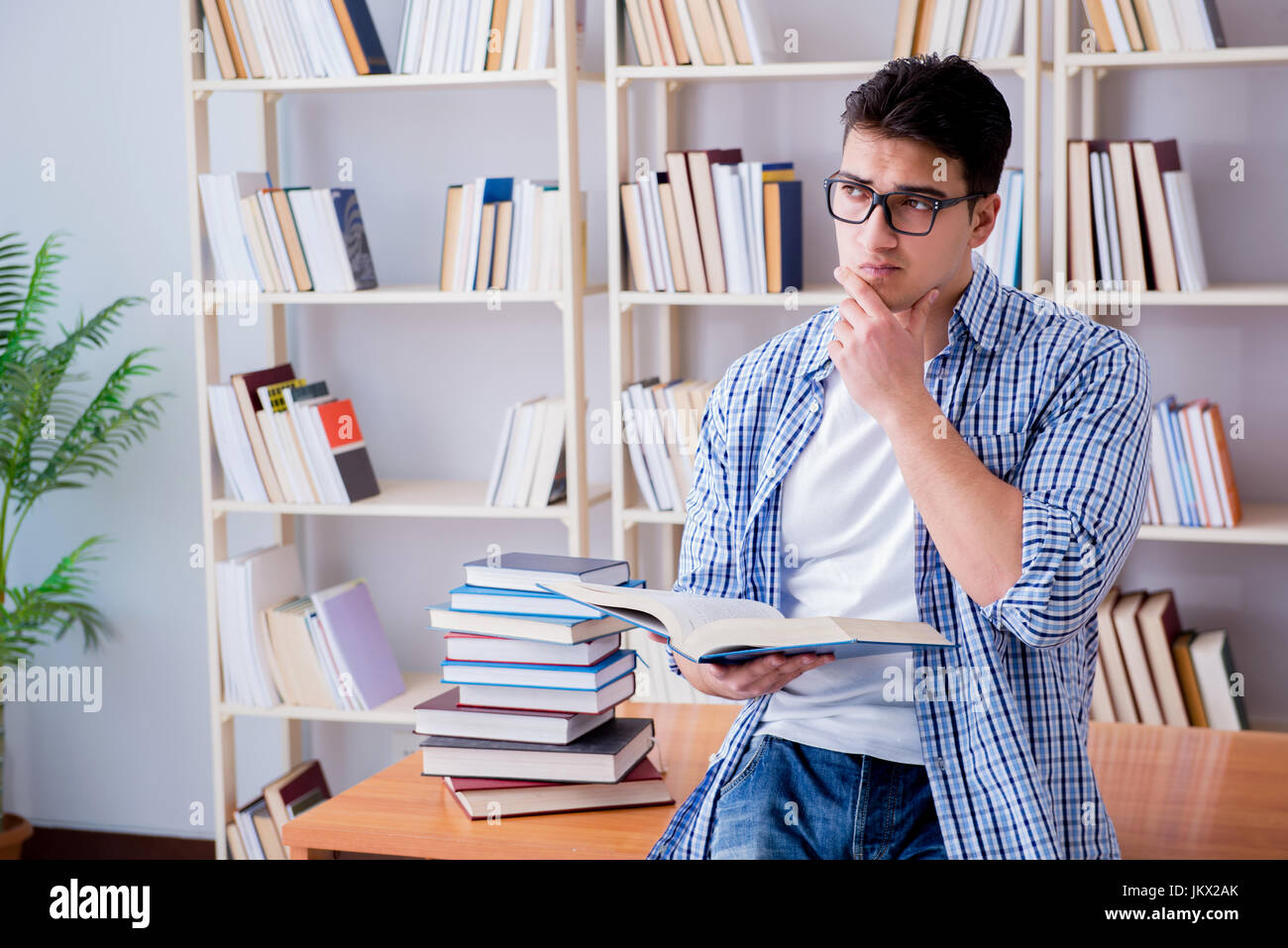 Young student with books preparing for exams Stock Photo - Alamy