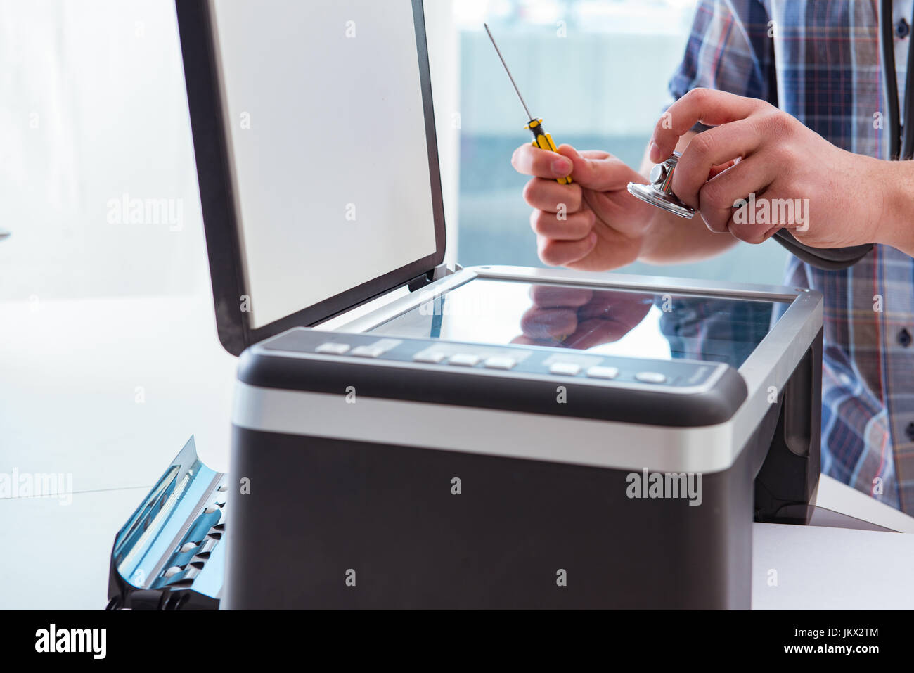 Repairman repairing broken color printer Stock Photo - Alamy