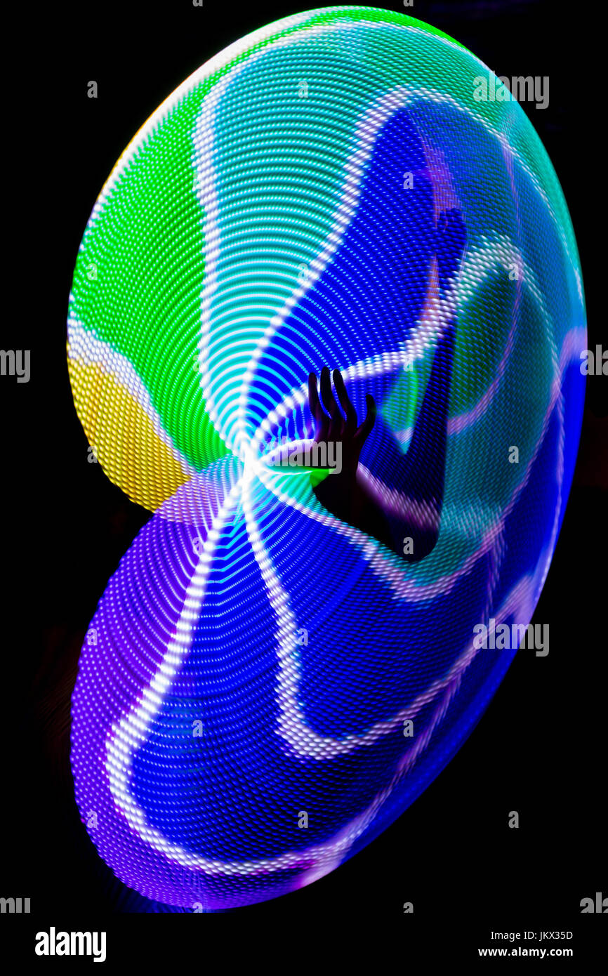 spinning LED hula hoop abstract with hand Stock Photo - Alamy