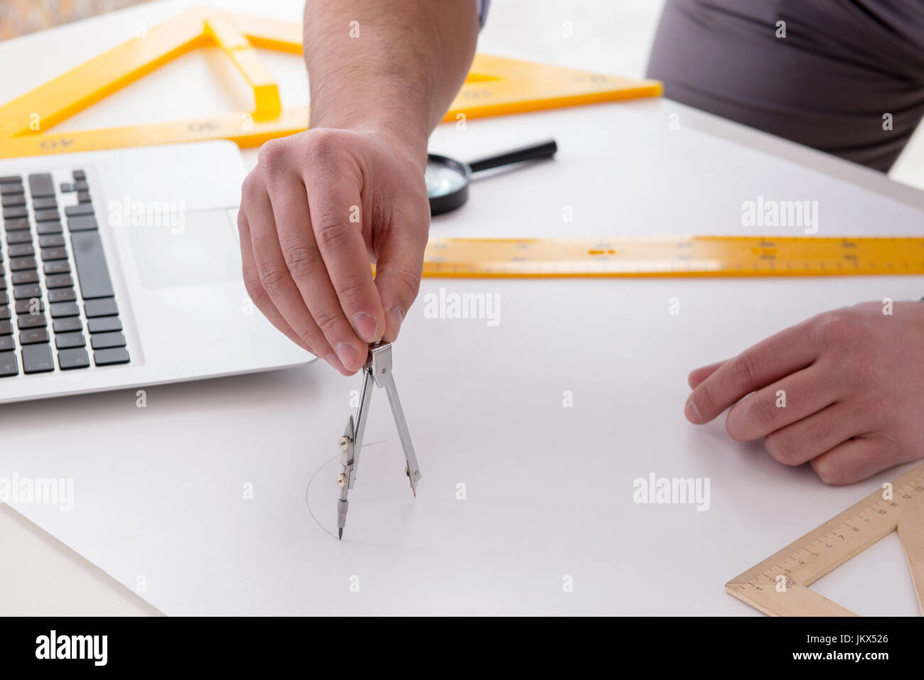 Male engineer working on drawings and blueprints Stock Photo - Alamy