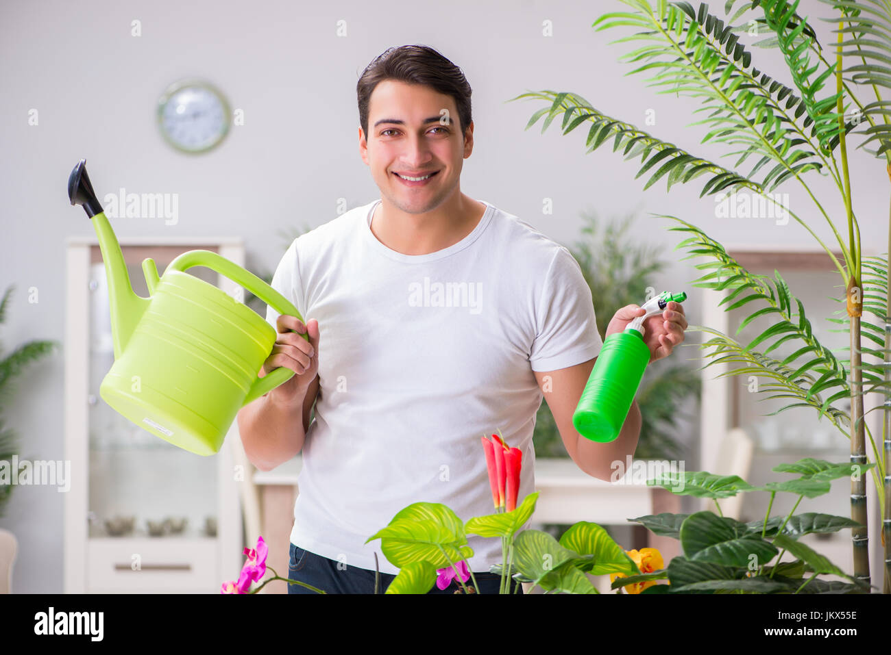 Young man in gardening concept at home Stock Photo - Alamy
