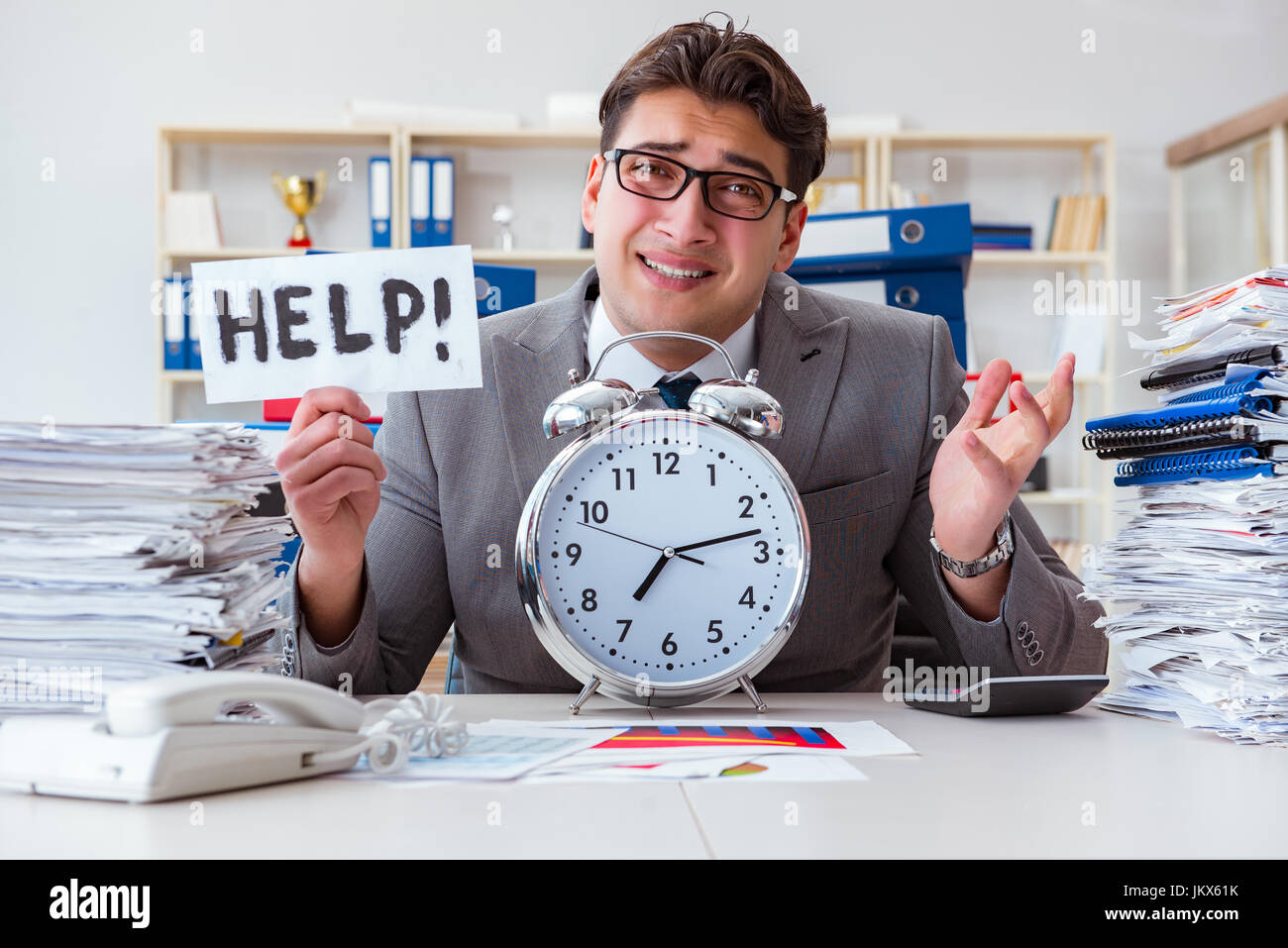 Businessman missing deadlines due to excessive work Stock Photo - Alamy