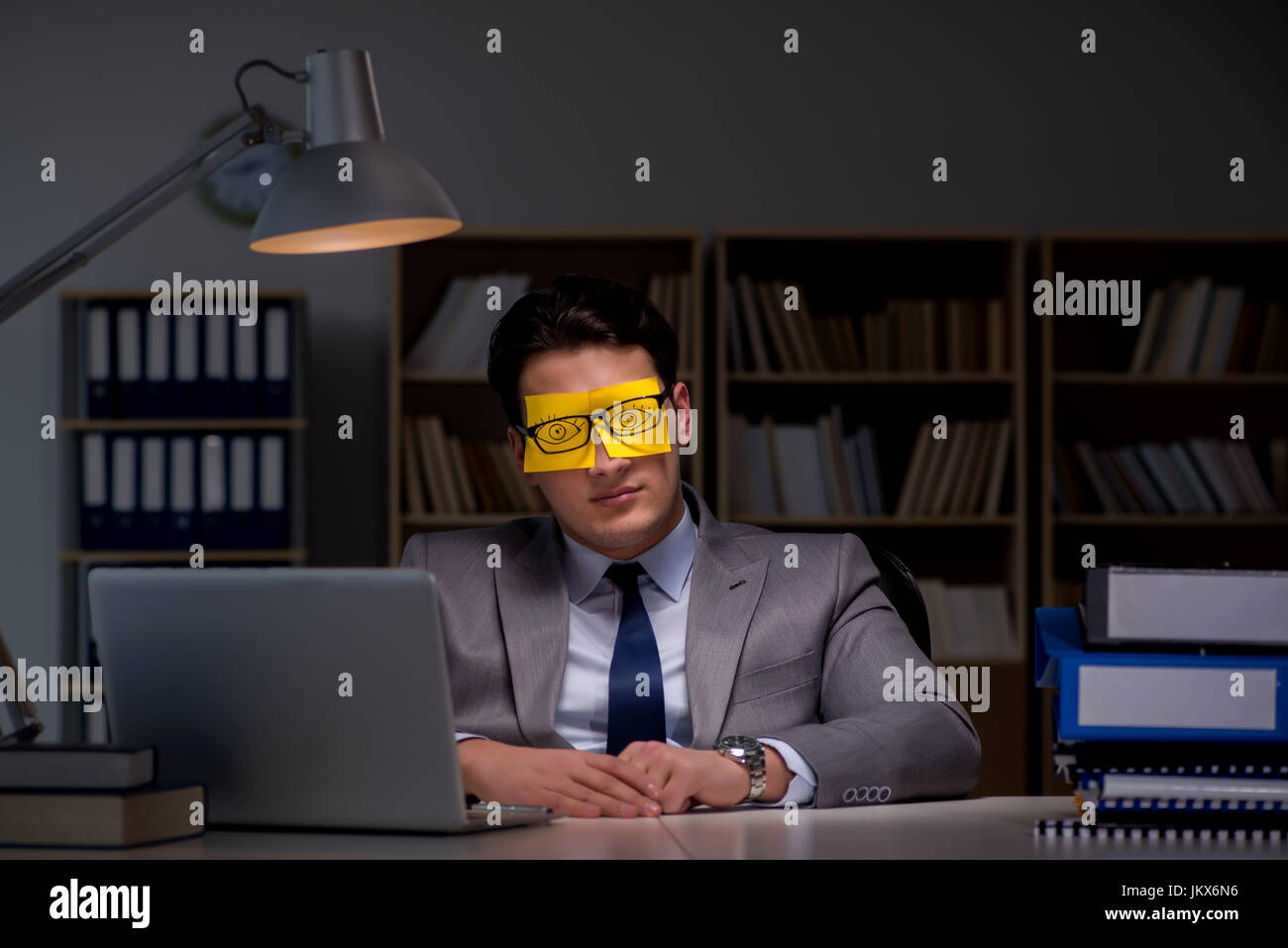 Businessman staying late to sort out priorities Stock Photo - Alamy