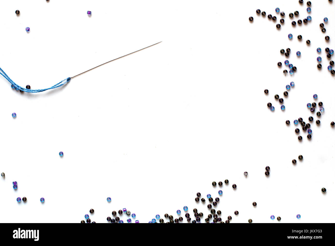 sewing needle with thread and beads on white. background, isolated ...