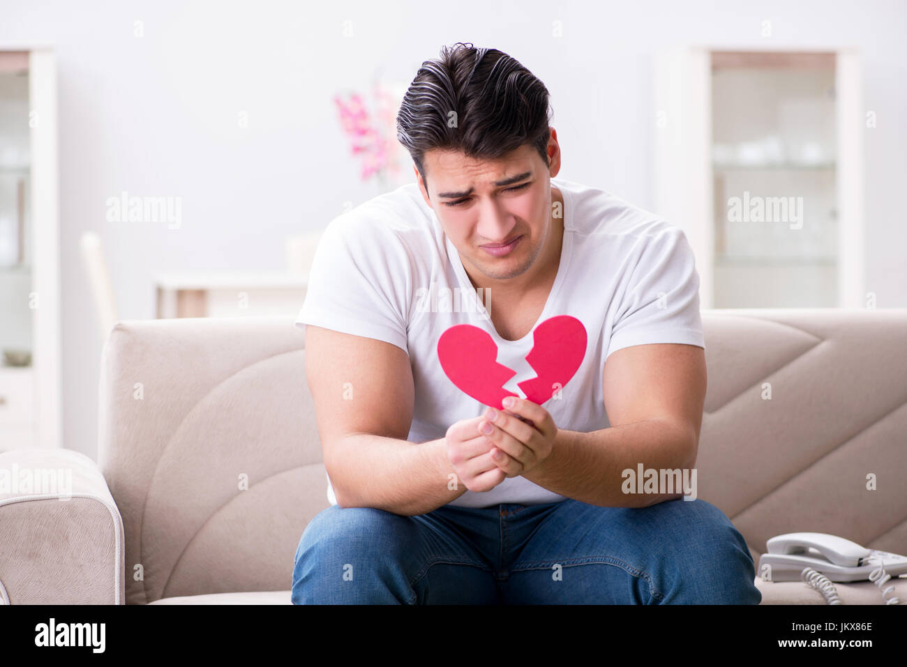 Young man in sad saint valentine concept Stock Photo - Alamy