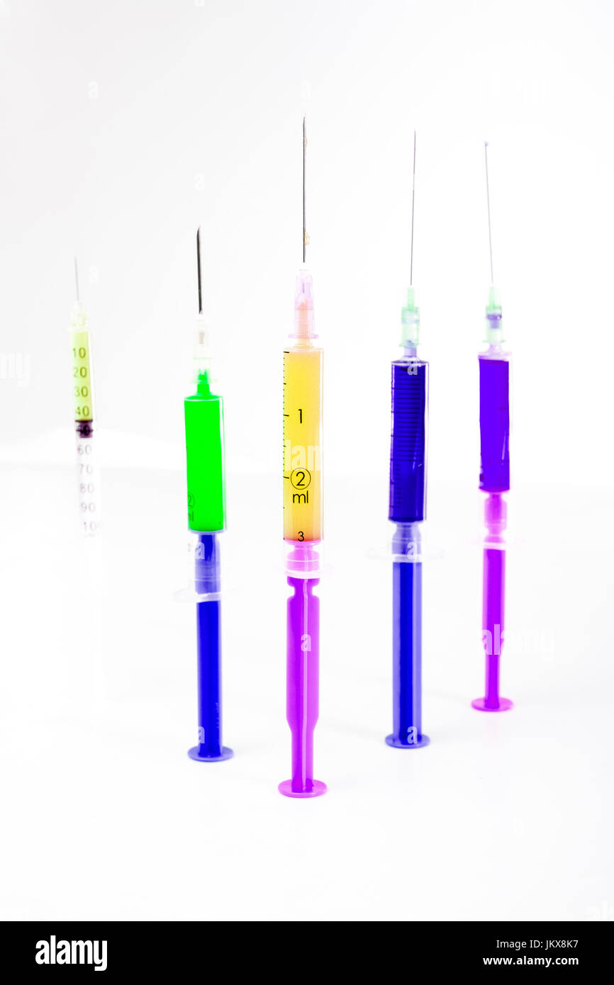 Syringes vaccination colorful injection tubes on isolated white studio ...