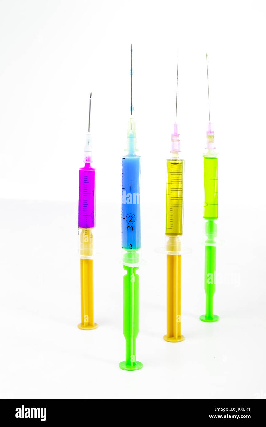 Syringes vaccination colorful injection tubes on isolated white studio ...