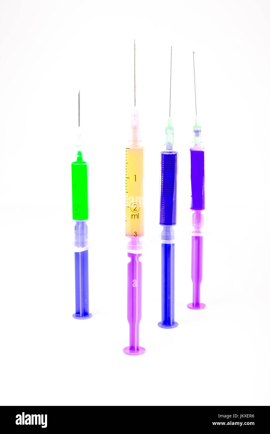 Syringes vaccination colorful injection tubes on isolated white studio ...