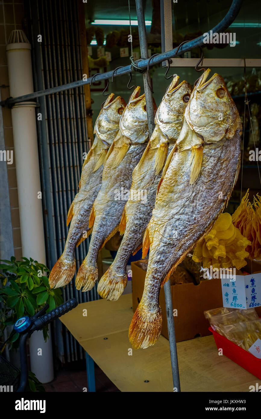 Fresh fish over a newspaper in a market in fishermen town in lantau ...