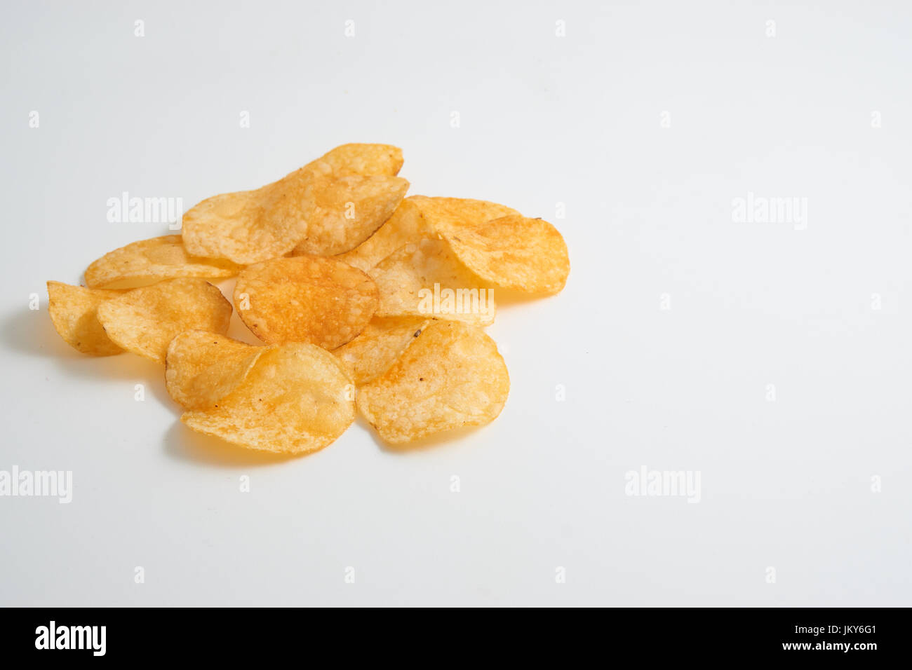 small pile of potato crisps on white background. low angle shot Stock ...