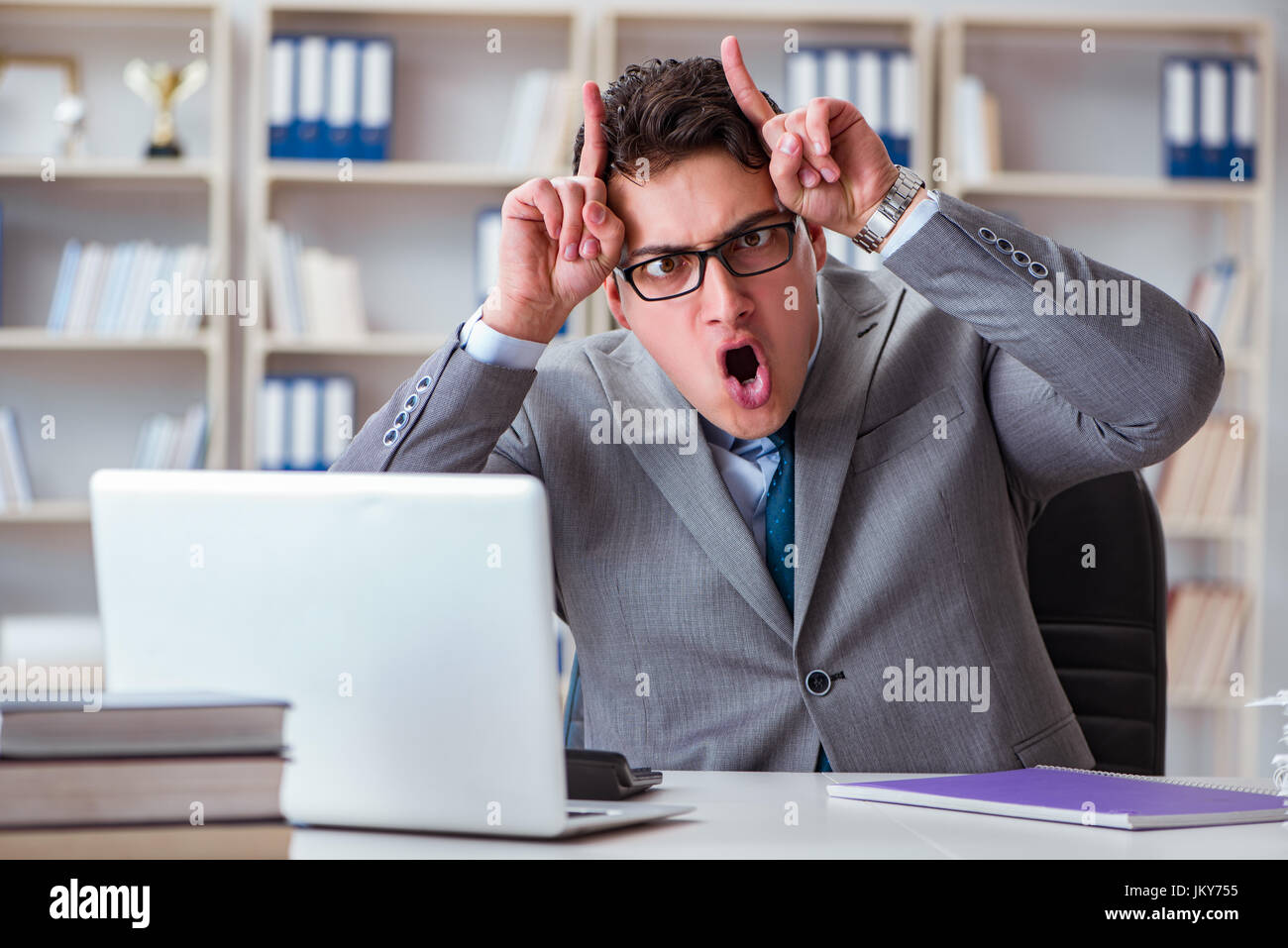 Funny businessman clown acting silly in the office Stock Photo - Alamy