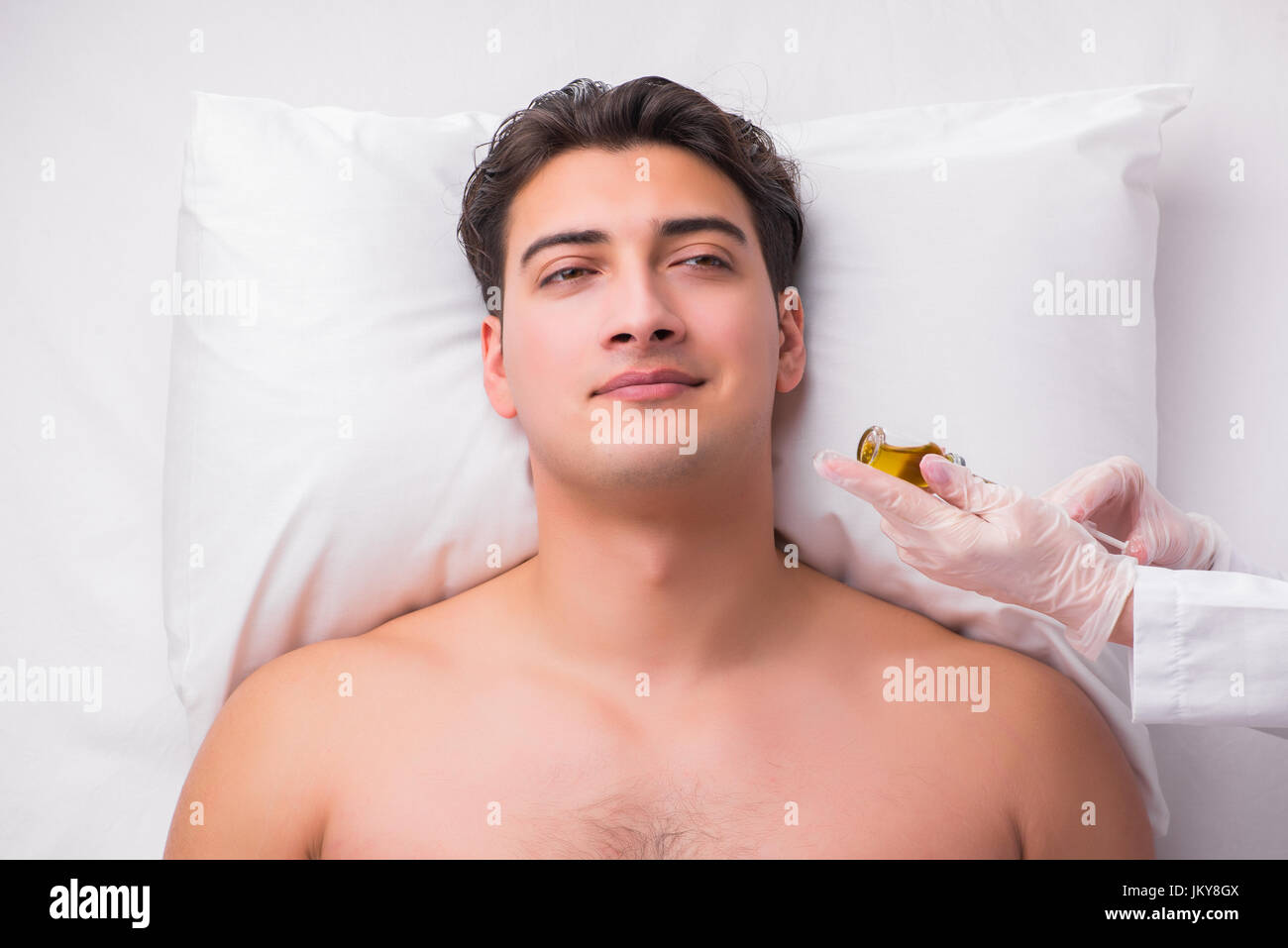 Handsome man in spa massage concept Stock Photo - Alamy