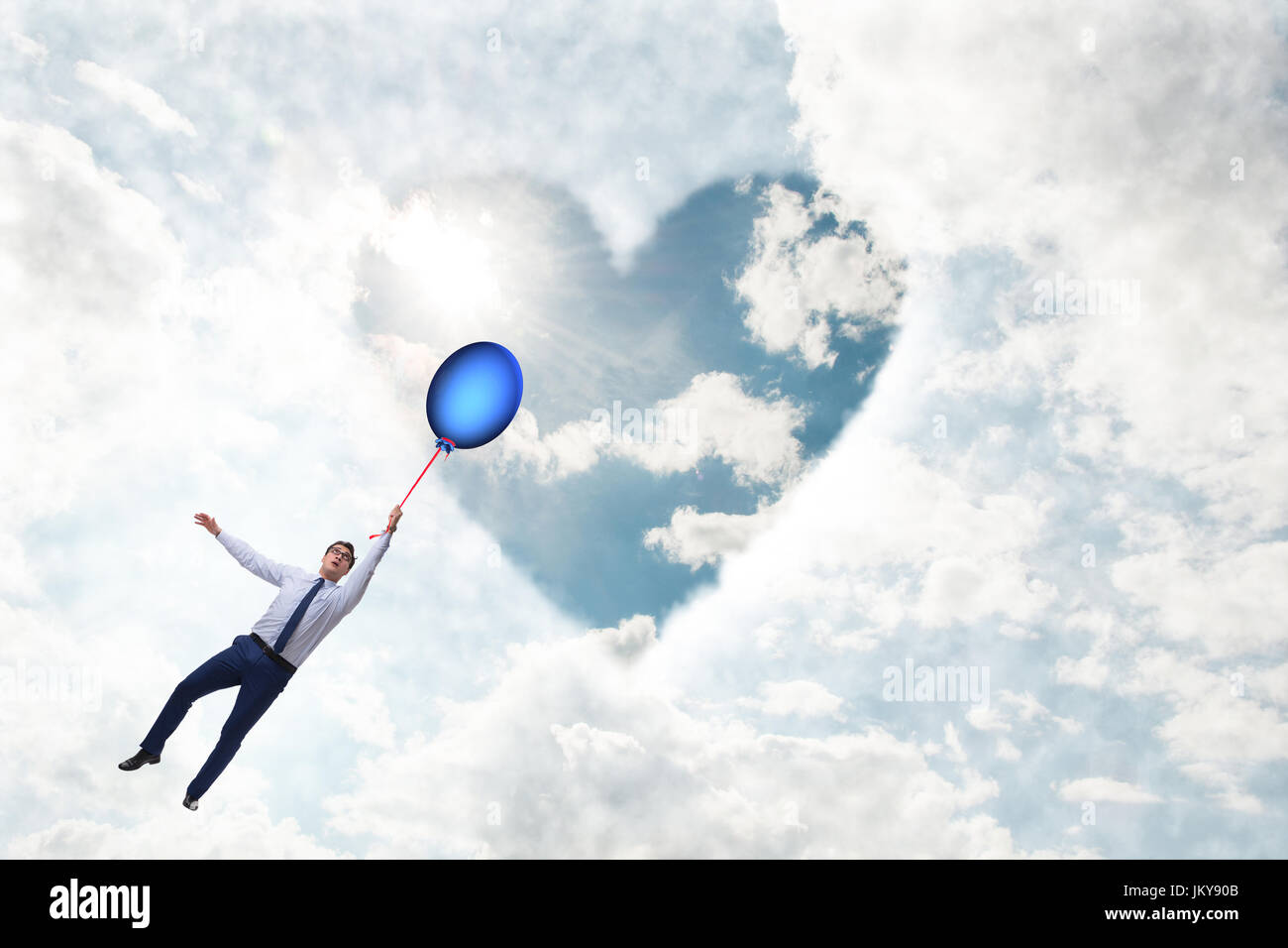 Man flying balloons in romantic concept Stock Photo - Alamy