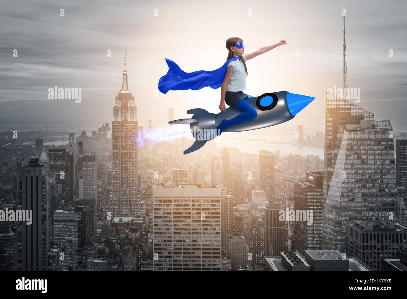 Little girl flying rocket in superhero concept Stock Photo - Alamy