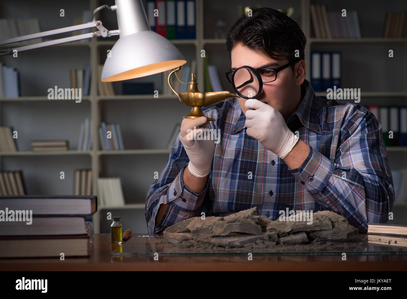 Archeologist working late night in office Stock Photo - Alamy