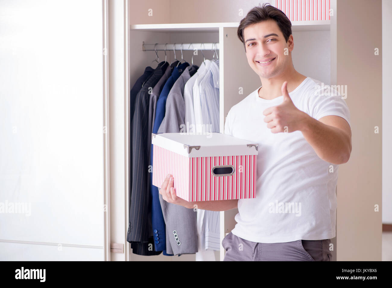 Young man businessman getting dressed for work Stock Photo - Alamy