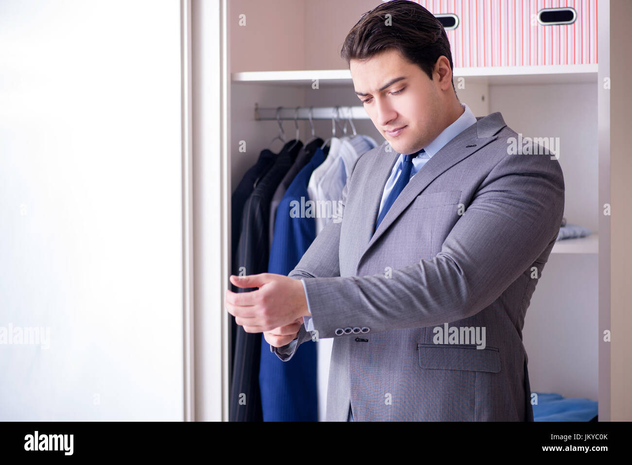 Young man businessman getting dressed for work Stock Photo - Alamy