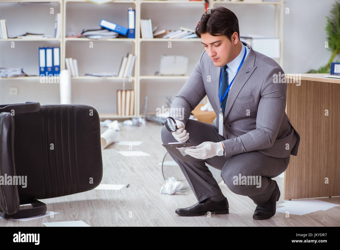 Young man during crime investigation in office Stock Photo - Alamy