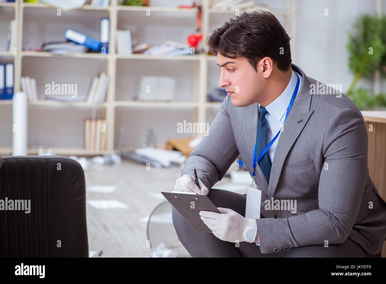 Young man during crime investigation in office Stock Photo - Alamy