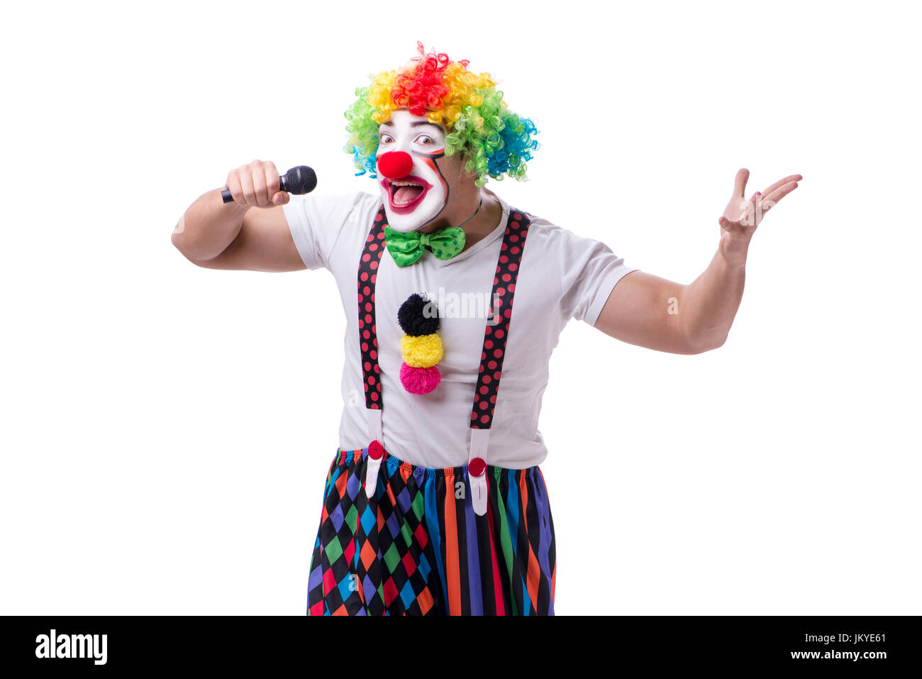 Funny clown with a microphone singing karaoke isolated on white ...