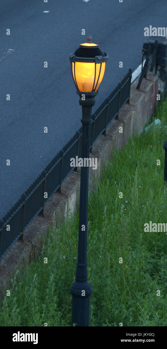 Streetlight on the side of a highway at twilight Stock Photo - Alamy