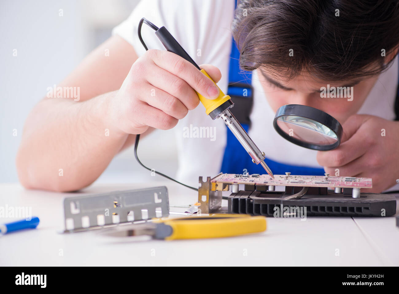 Computer repairman repairing desktop computer Stock Photo - Alamy