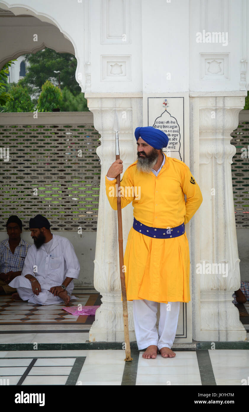 Amritsar, India - Jul 25, 2015. A Sikh guard working at the Golden ...