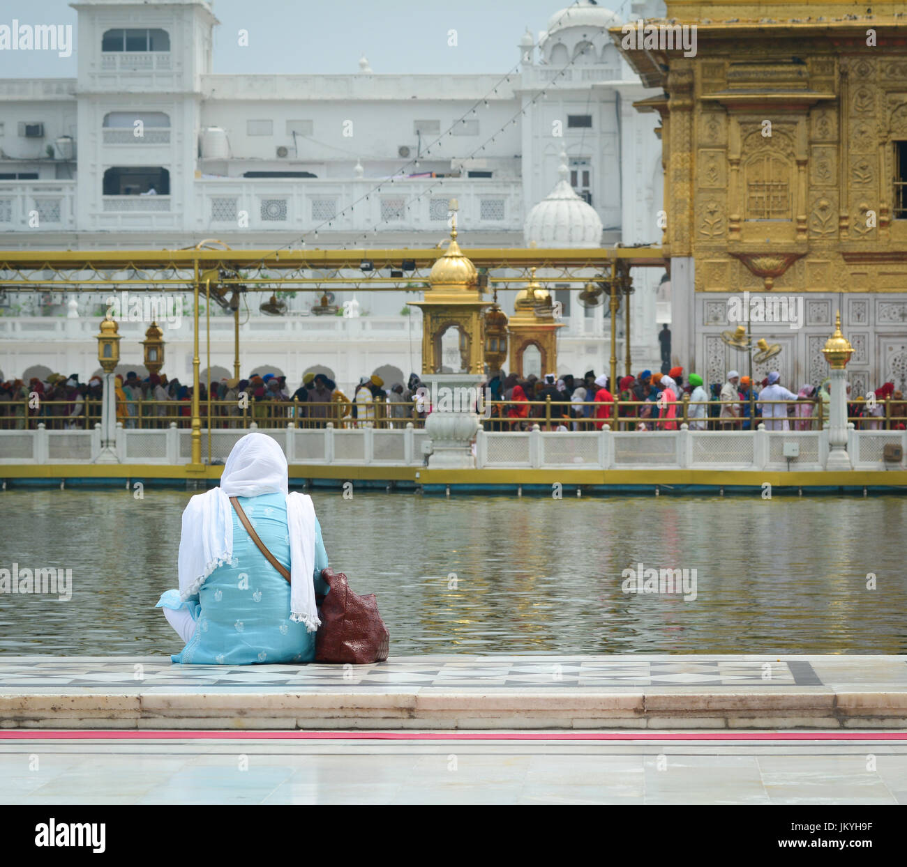 An Indian woman sitting at the Golden Temple in Amritsar, India. Golden ...