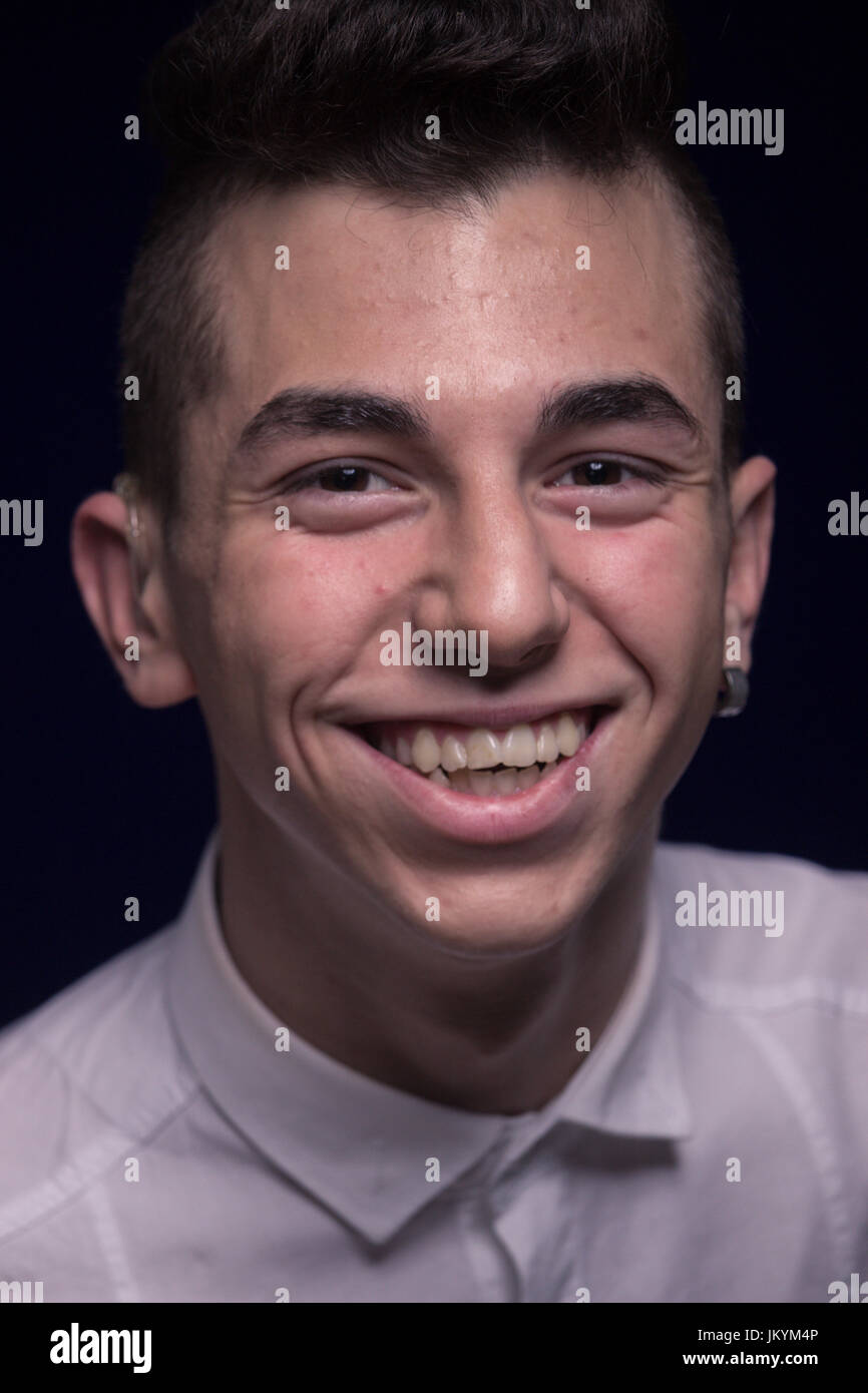 One teenager boy, head and shoulders shot, white shirt, face head ...