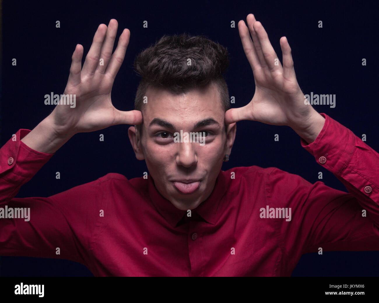 funny face, funny expression, one teenager boy, tongue out, hands next ...