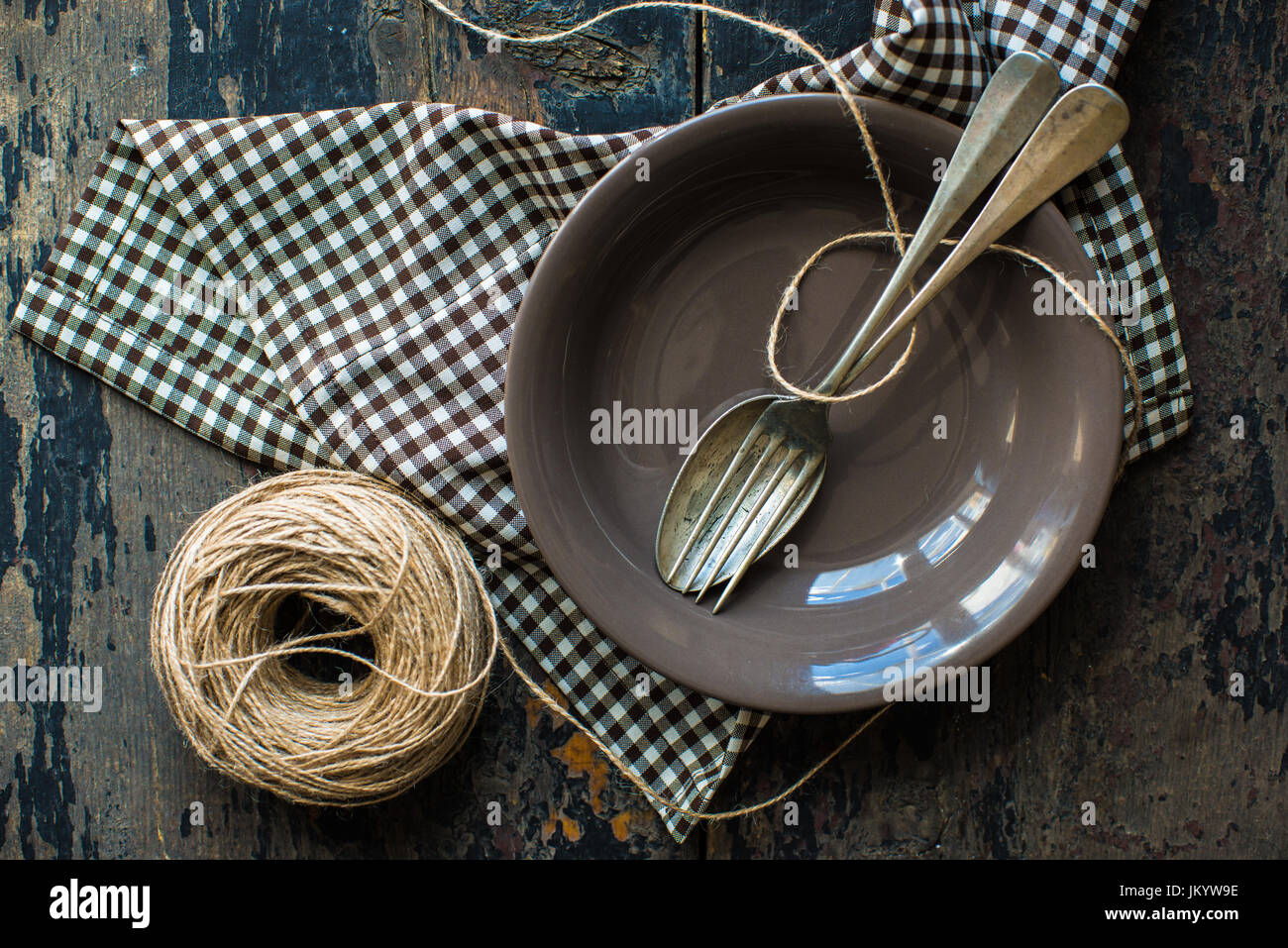 Rustic table setting with vintage bowls and silverware on dark old ...