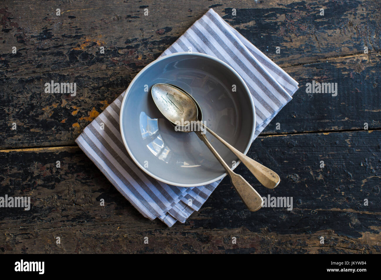 Rustic table setting with vintage bowls and silverware on dark old ...