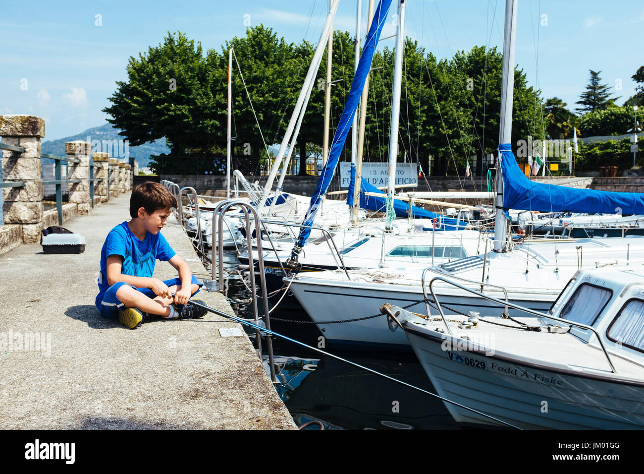 Child fishing at the harbor Stock Photo - Alamy