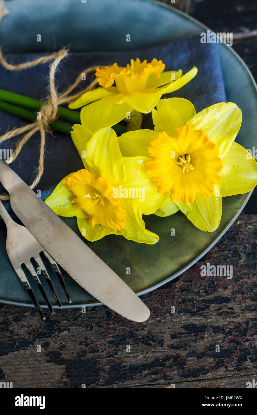 Spring table setting for Easter dinner with bright plates and bright ...