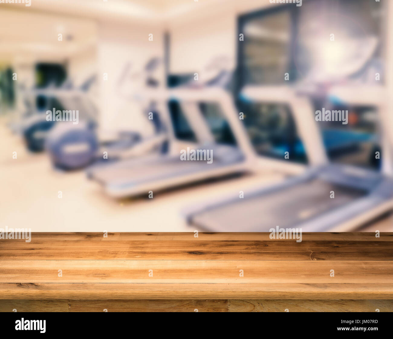 wooden floor with workout gym blurred background Stock Photo - Alamy