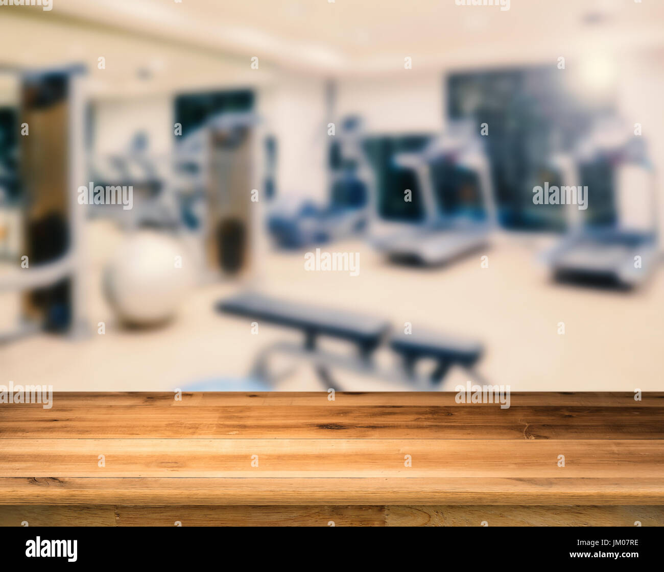 wooden floor with workout gym blurred background Stock Photo - Alamy