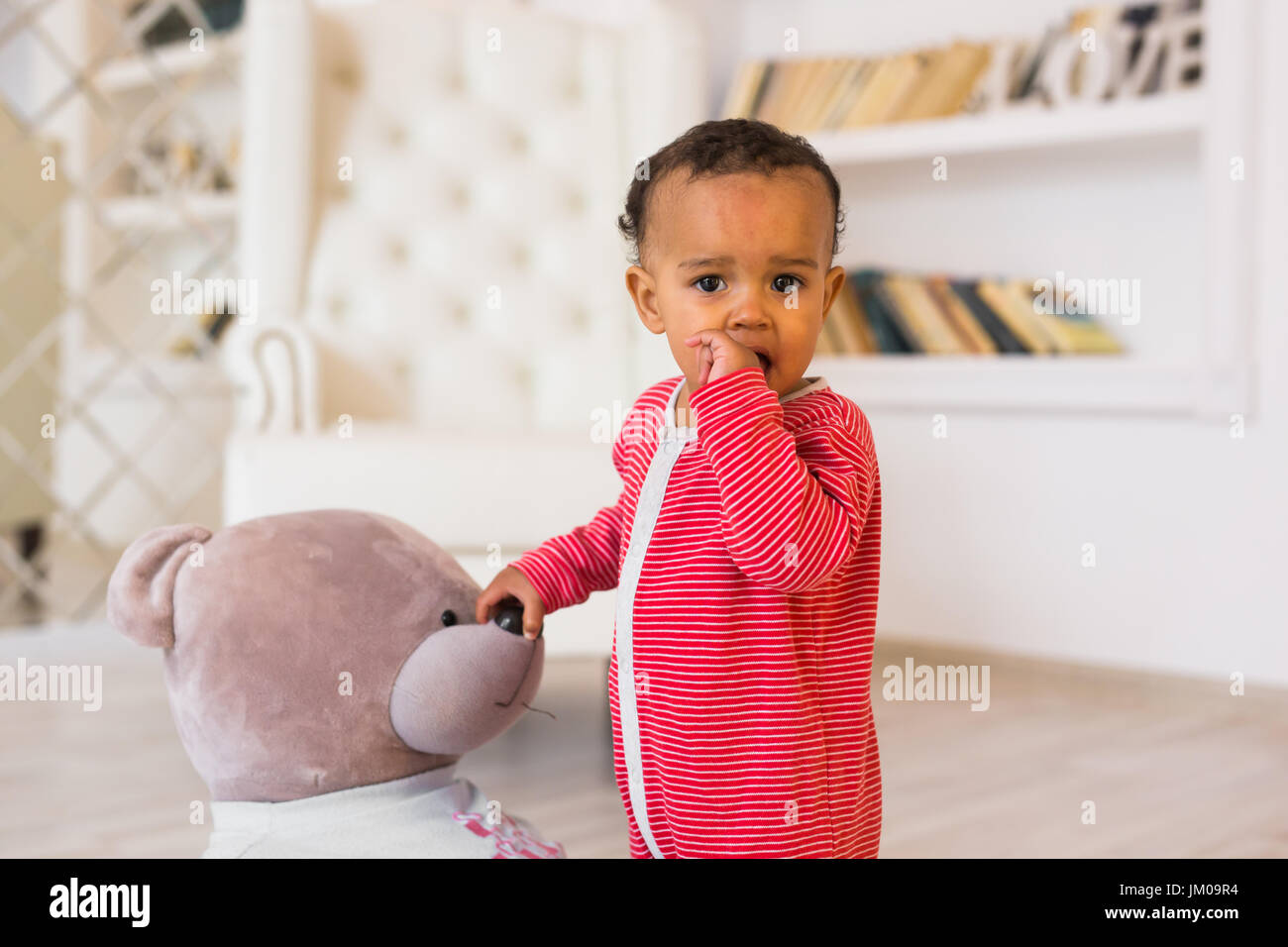 Cute curious baby study things in the room Stock Photo - Alamy