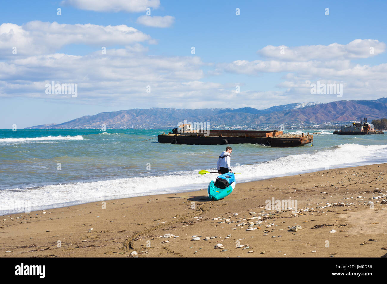 Man walking on the beach with kayak. Traveling by sea. Leisure ...